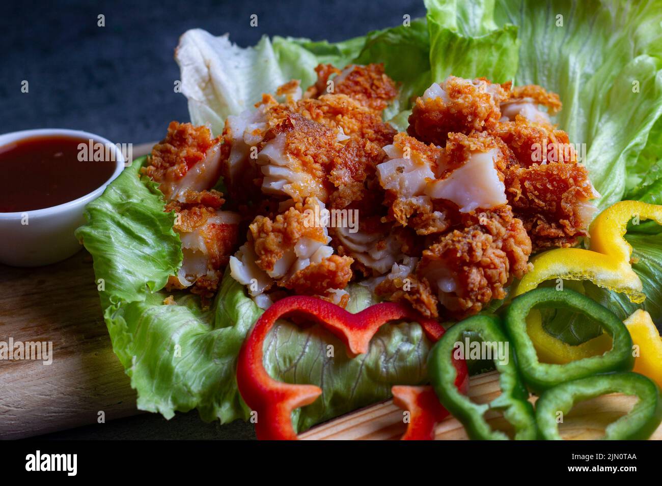 Crispy fish Popcorn with honey mustard sauce on wooden background Stock ...