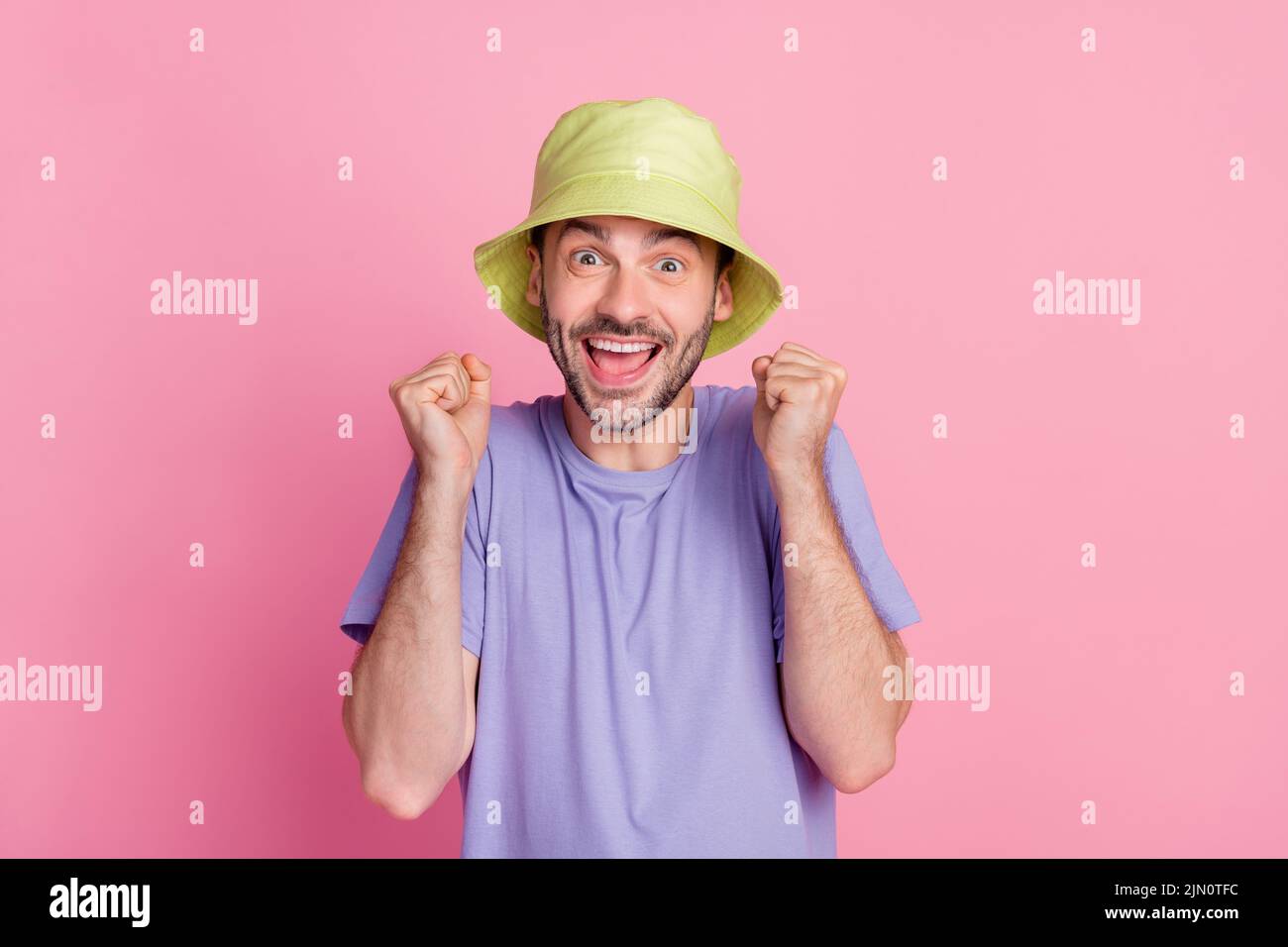 Photo of delighted guy raises arm fist up enjoy rejoice celebrate luck ...