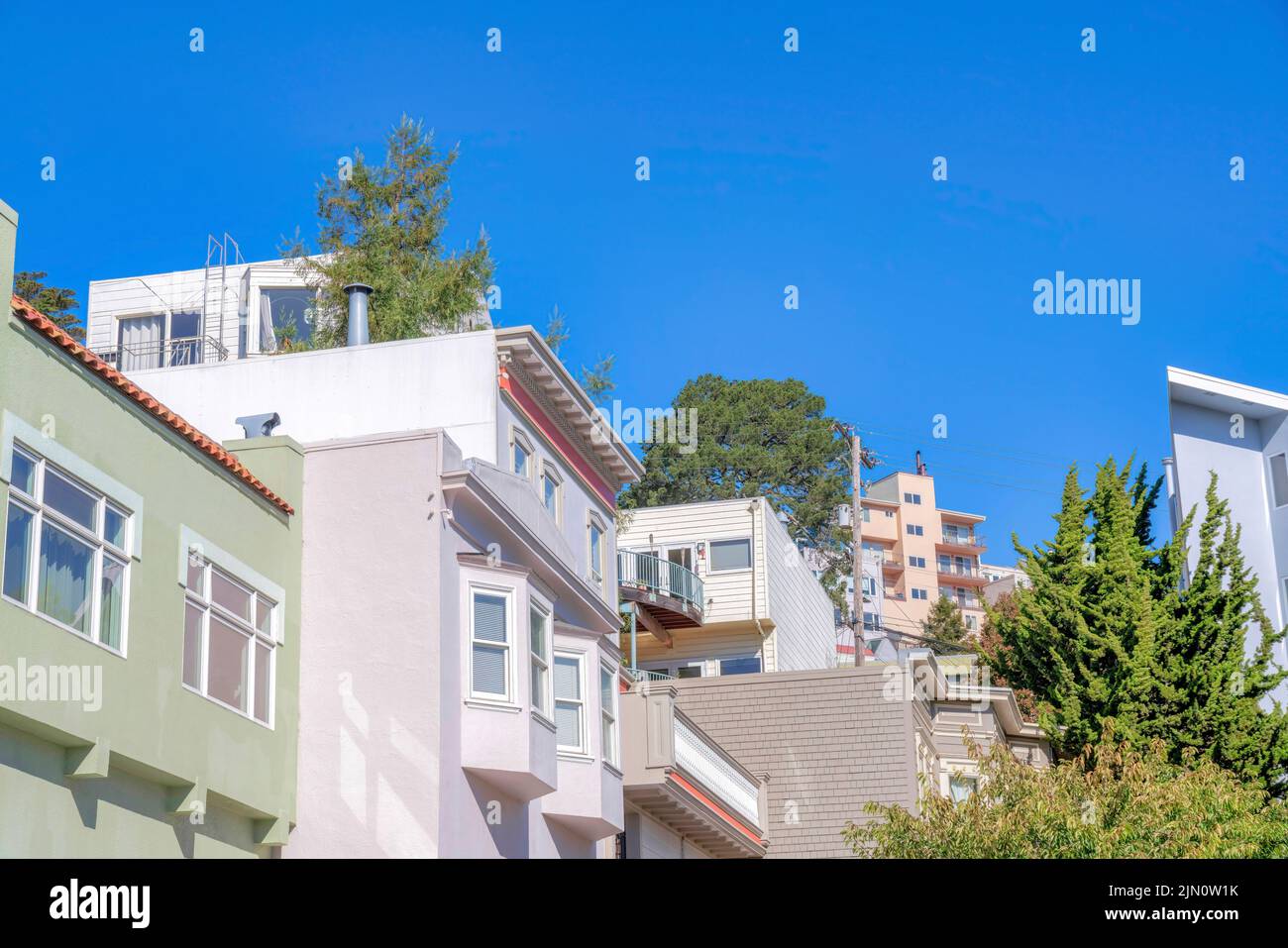 Adjacent houses on a sloped neighborhood at San Francisco, California ...