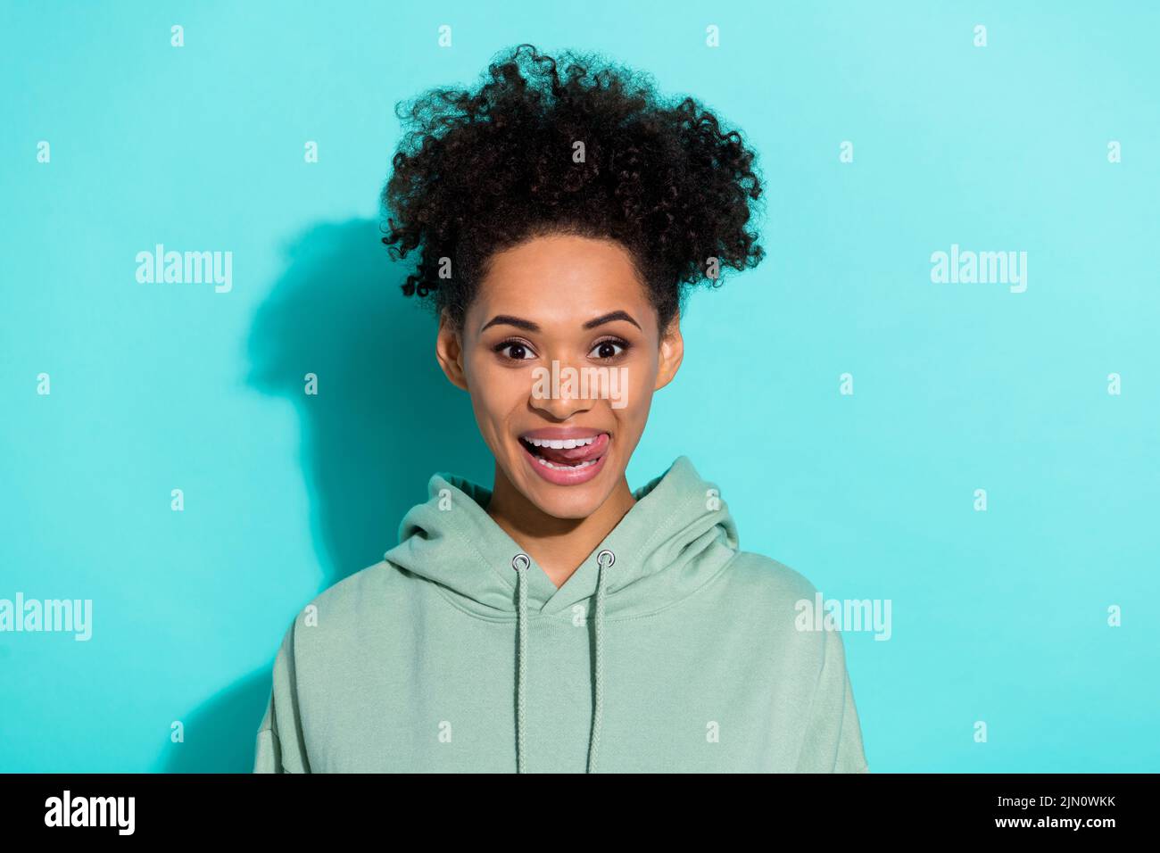 Portrait of positive pretty person tongue lick white teeth look camera ...