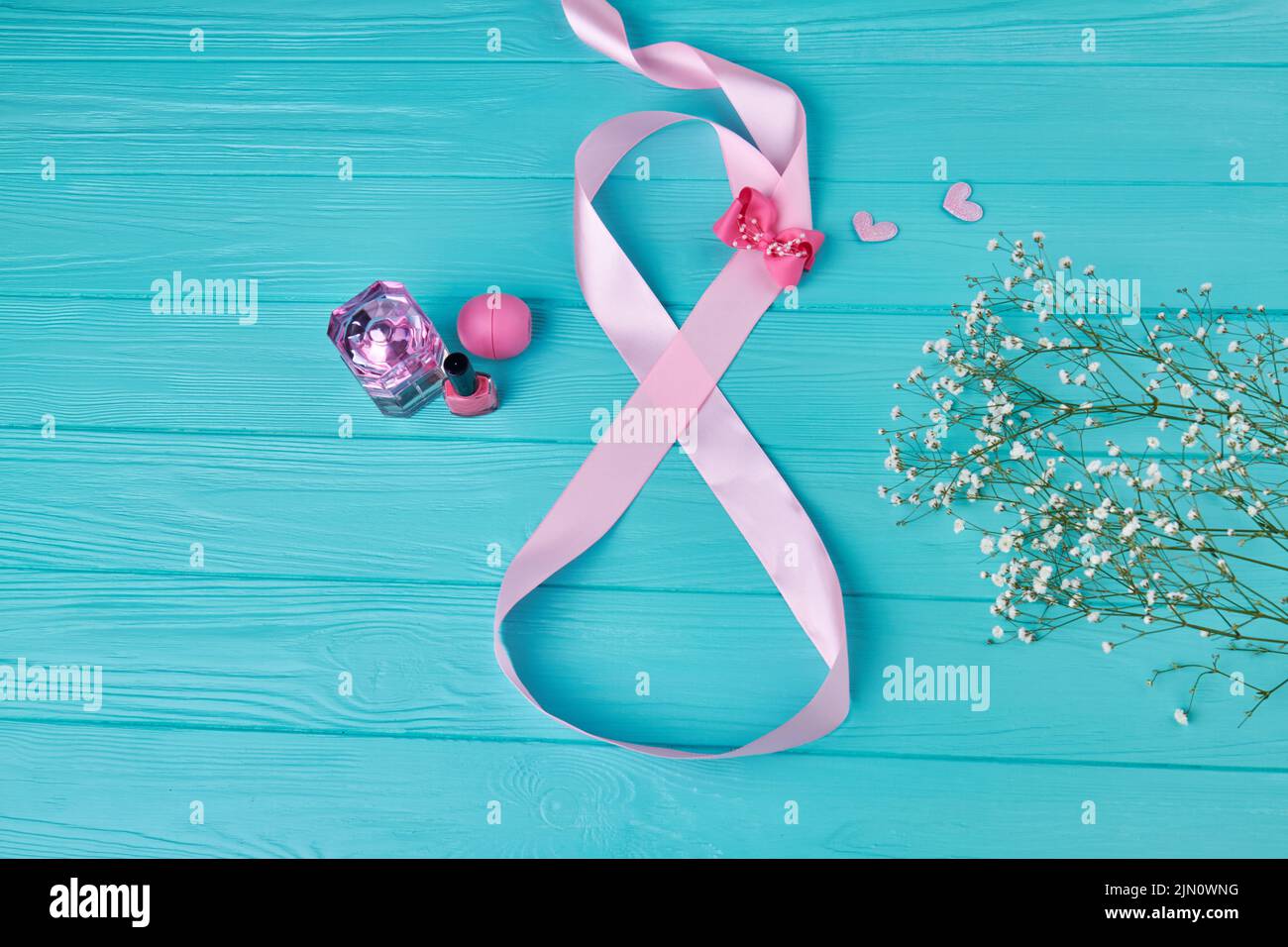 Flat lay top view womens day concept. Pink tape twisted in eight number ...