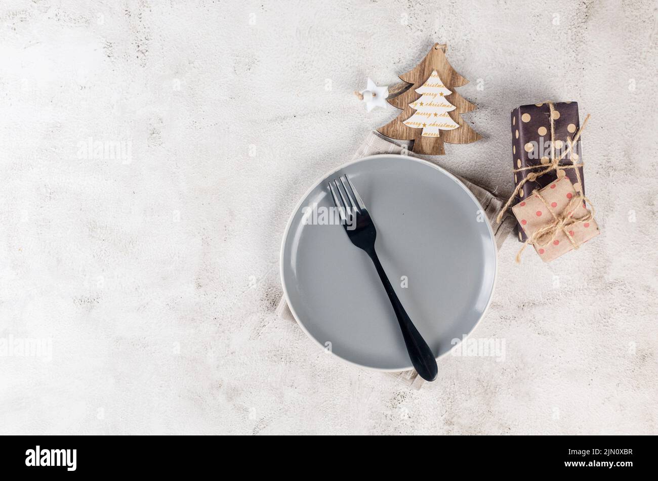 Christmas table setting. Top view of empty grey plate with black ...
