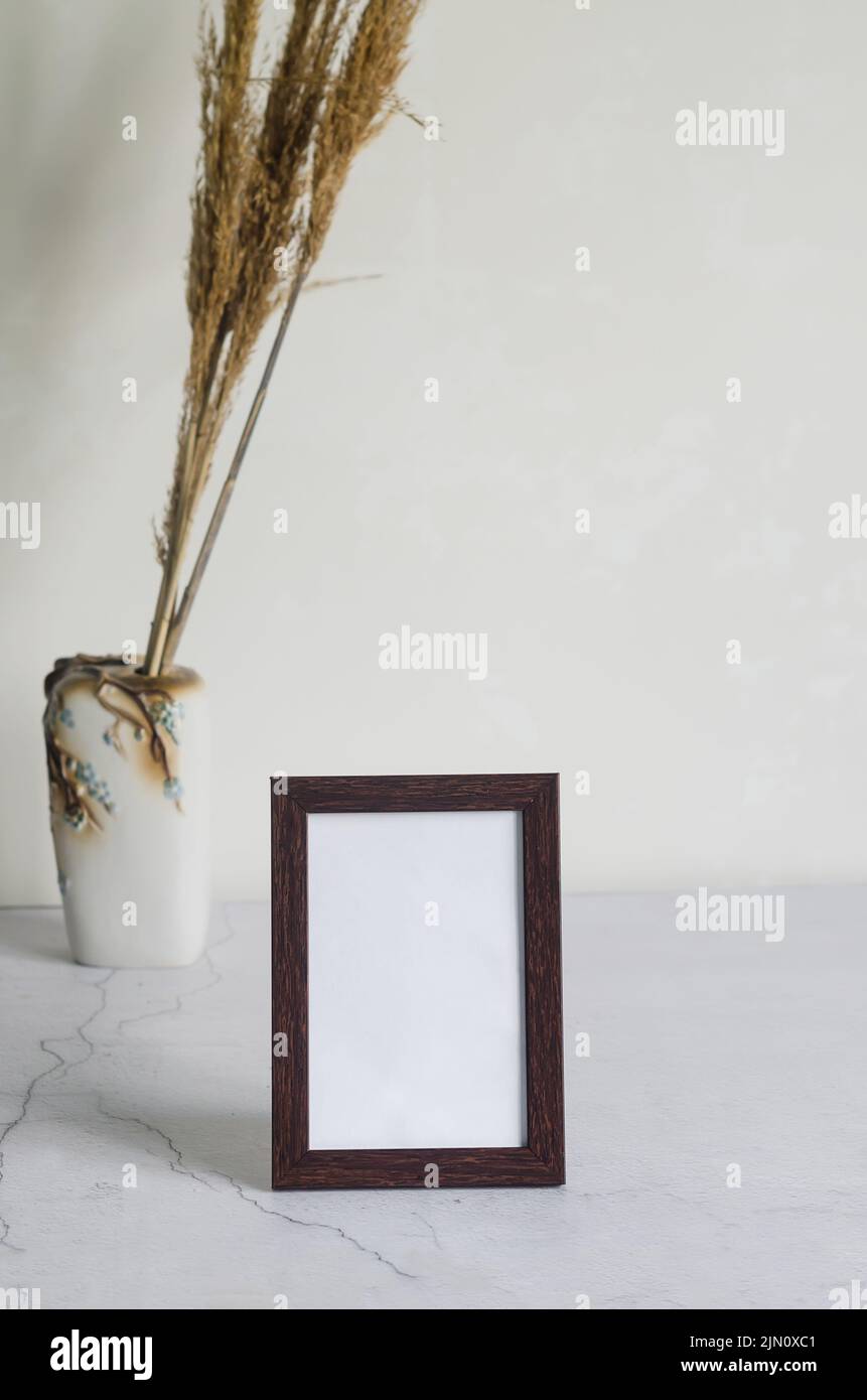 Empty paper business card mock-up over green olive tree leaves on grey ...