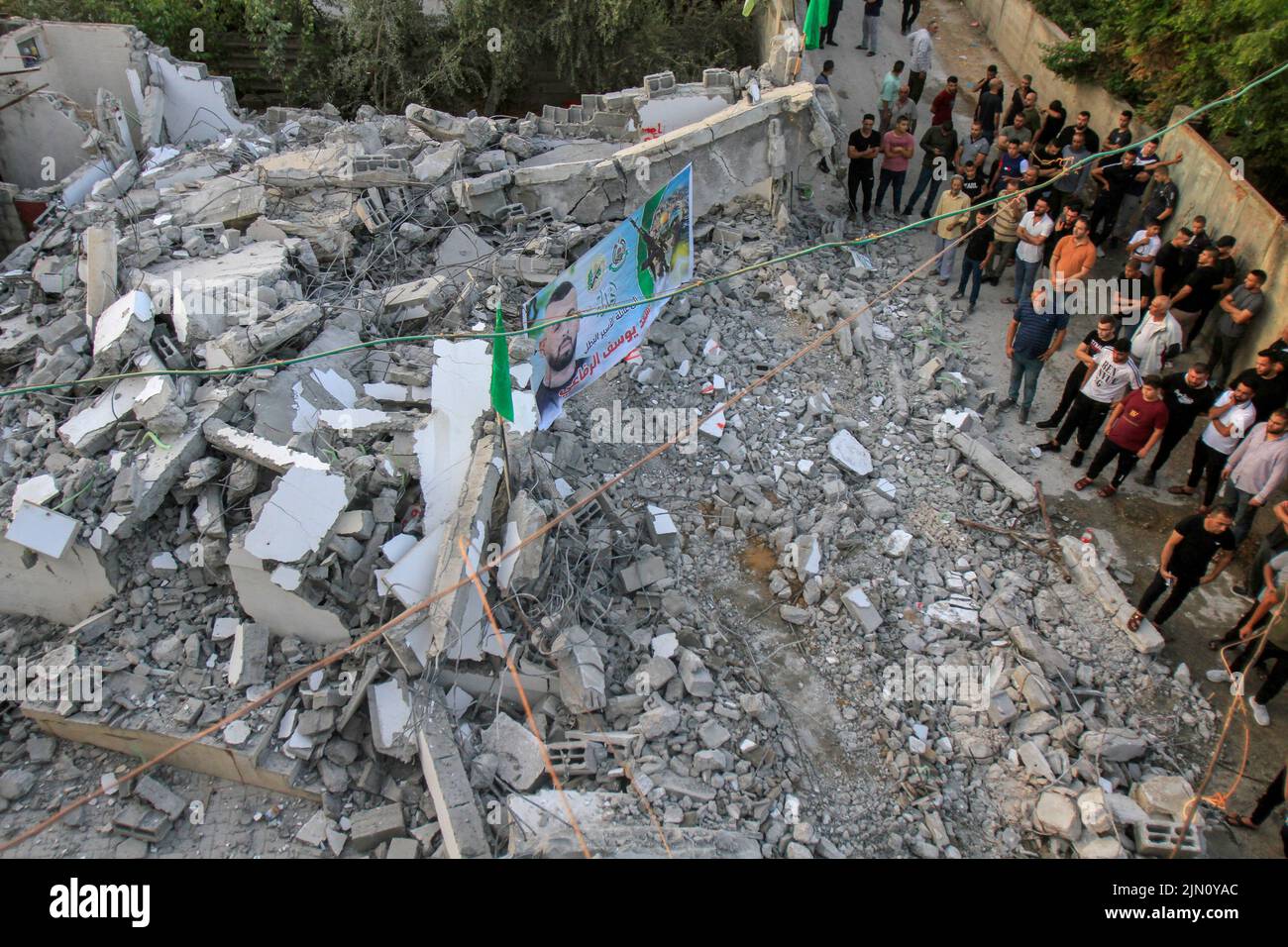 Palestinians inspect the house of Hassan Al-Rifai, following its ...