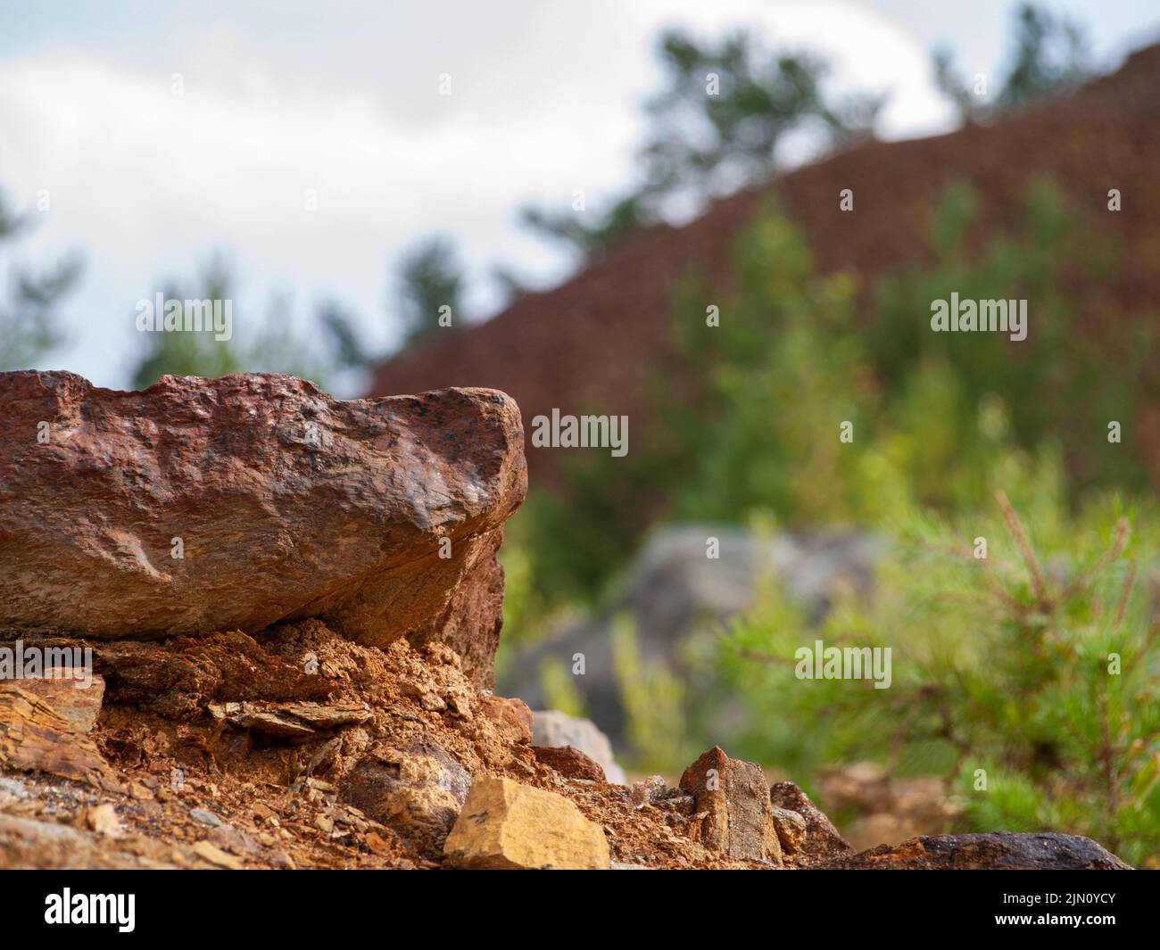 Stone in focus with mountain of slag from Falun Copper Mine World ...