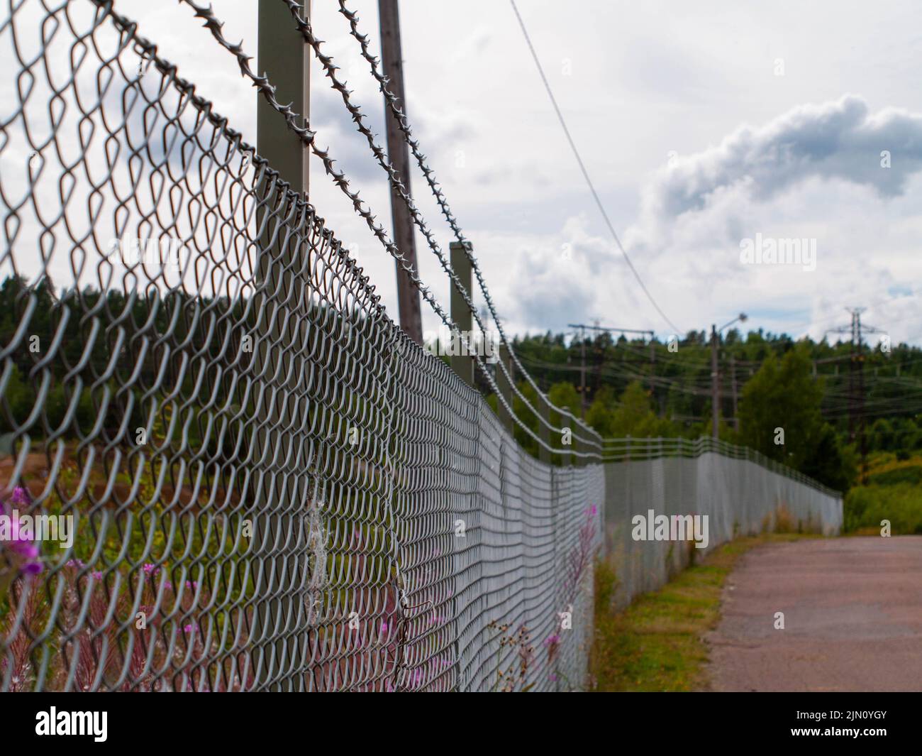 Barbed wired fence in old industry landscape almost post apocalyptic ...