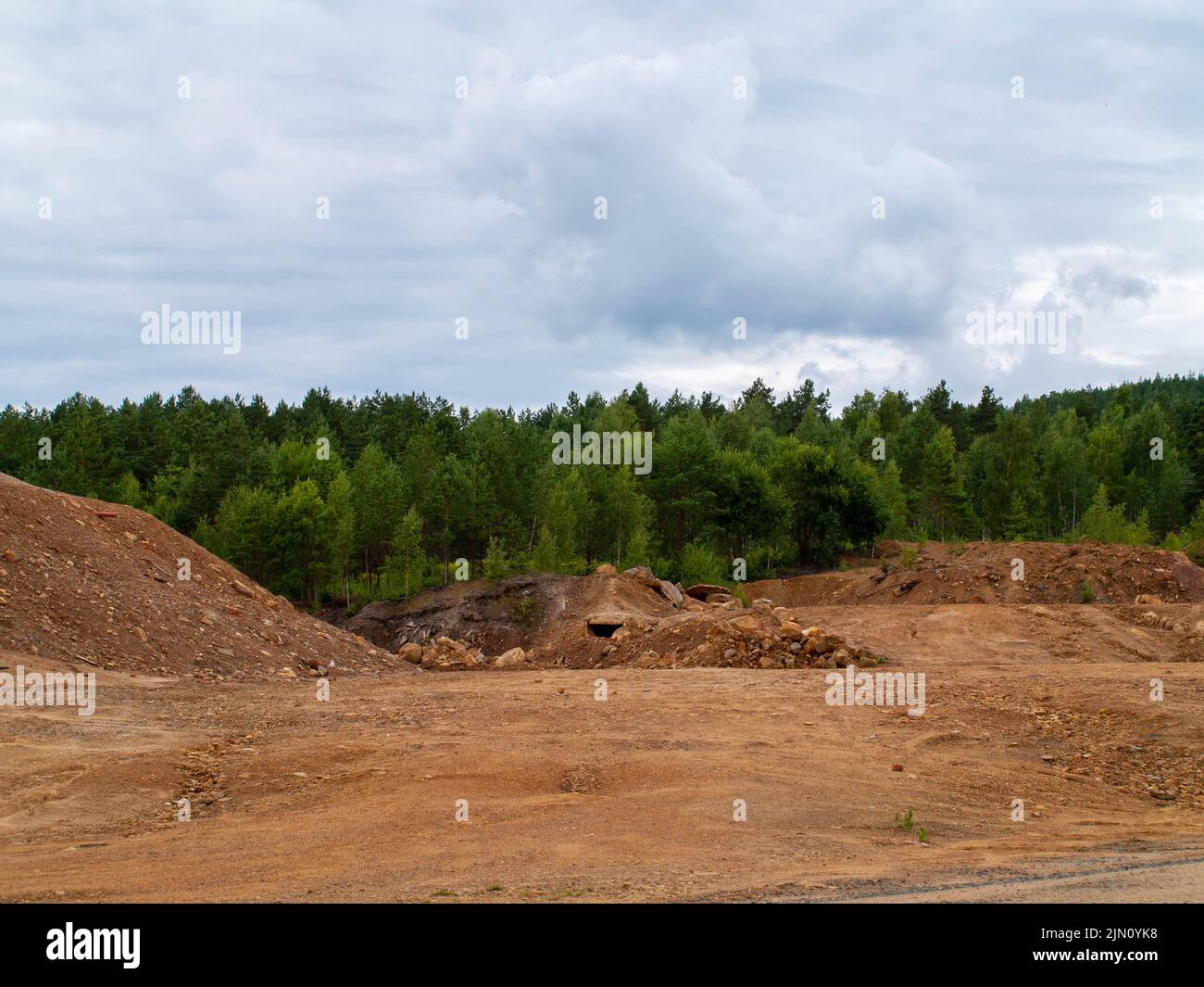 Mystierious cave opening in the distance in an orange post apocalyptic ...
