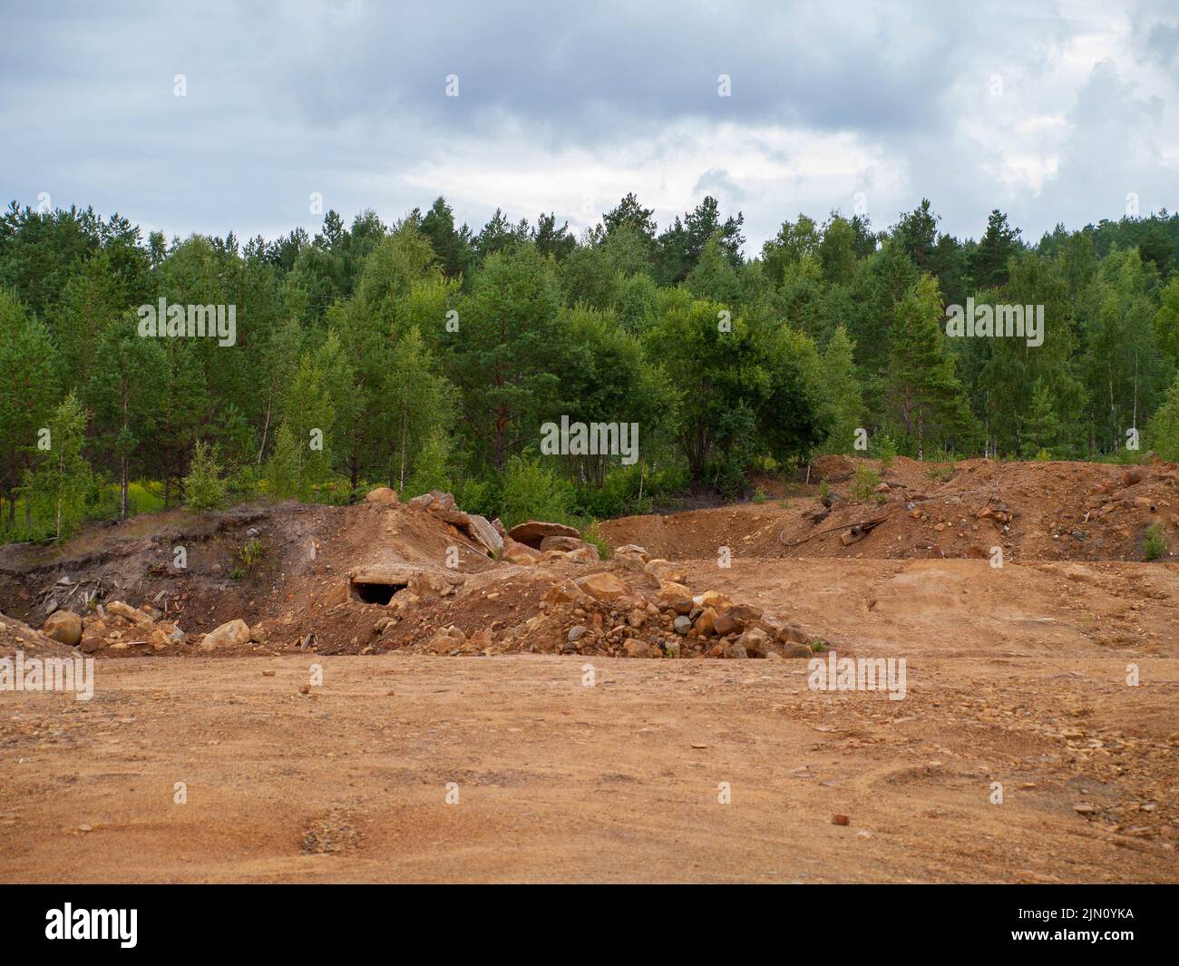 Mystierious cave opening in the distance in an orange post apocalyptic ...