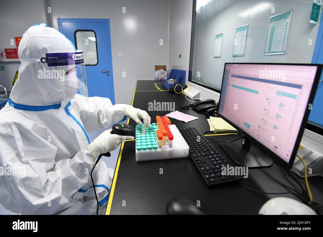 GUIYANG, CHINA - AUGUST 8, 2022 - Laboratory staff scan and enter Novel ...