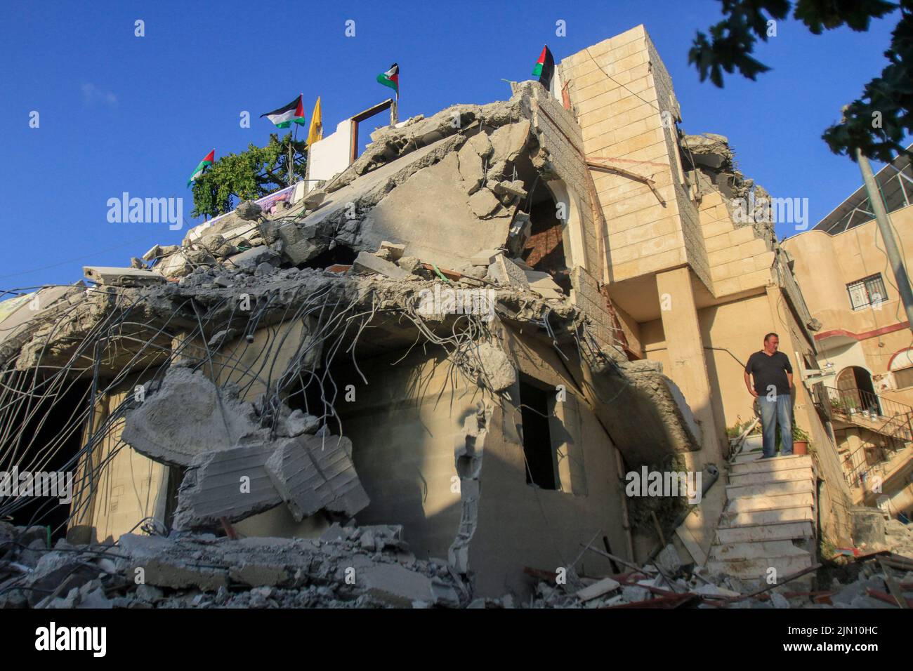 Jenin, Palestine. 2nd Aug, 2022. A Palestinian inspects the house of ...