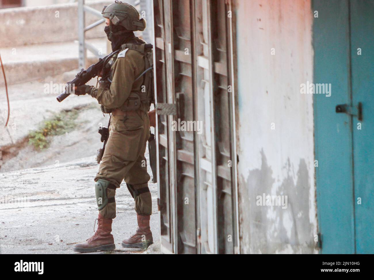 Jenin, Palestine. 2nd Aug, 2022. An Israeli soldier takes his position ...