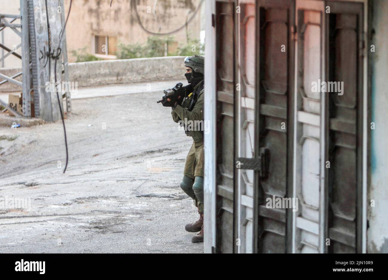 Jenin, Palestine. 2nd Aug, 2022. An Israeli soldier takes his position ...
