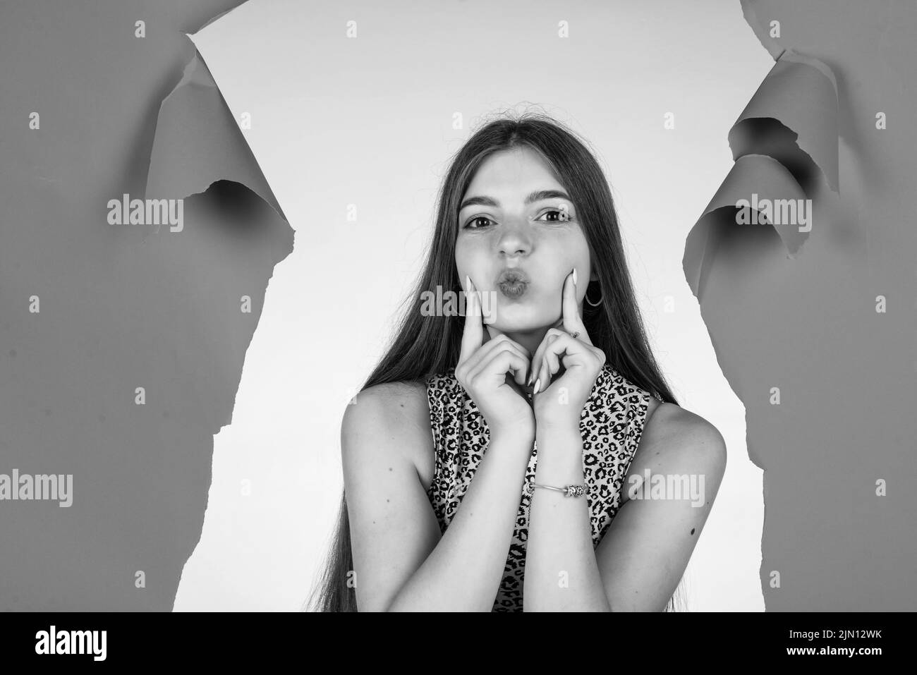 stylish child girl looking funny on blue background, human emotions ...