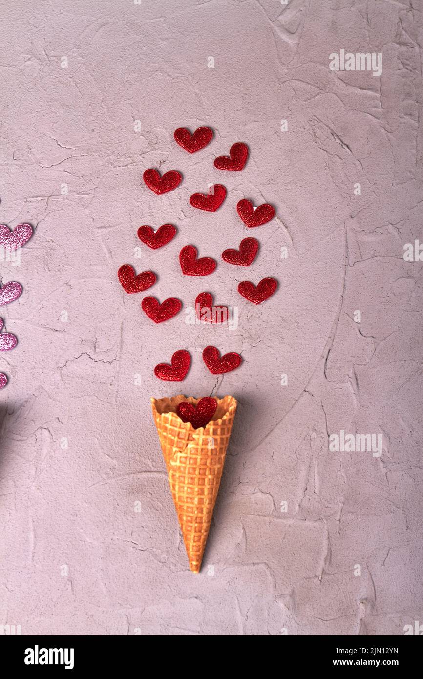 Vertical shot ice cream cone with red hearts. Top view flat lay Stock ...