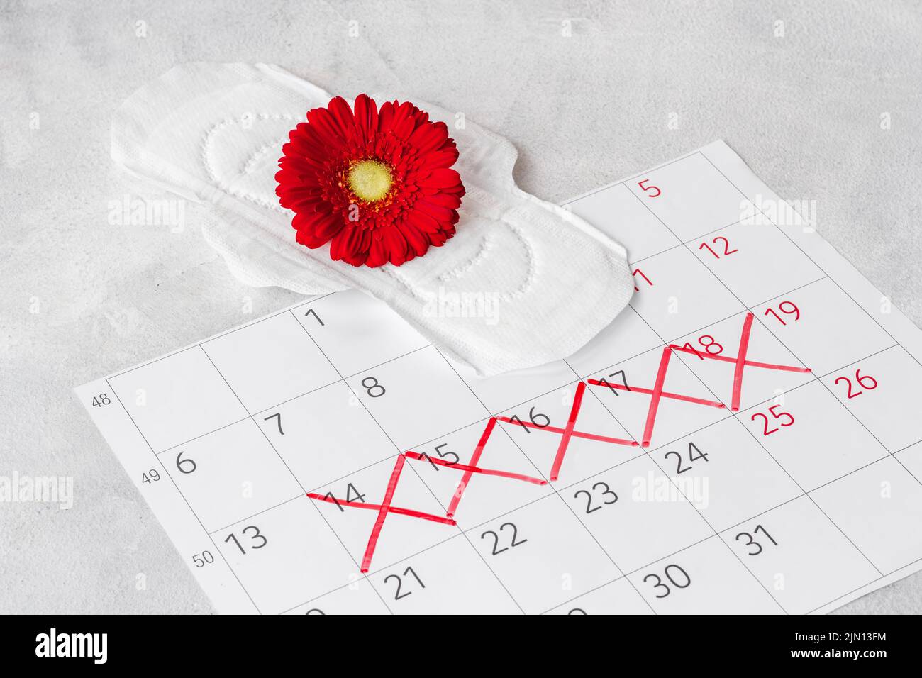 Menstruation period concept with calendar and white pad Stock Photo - Alamy