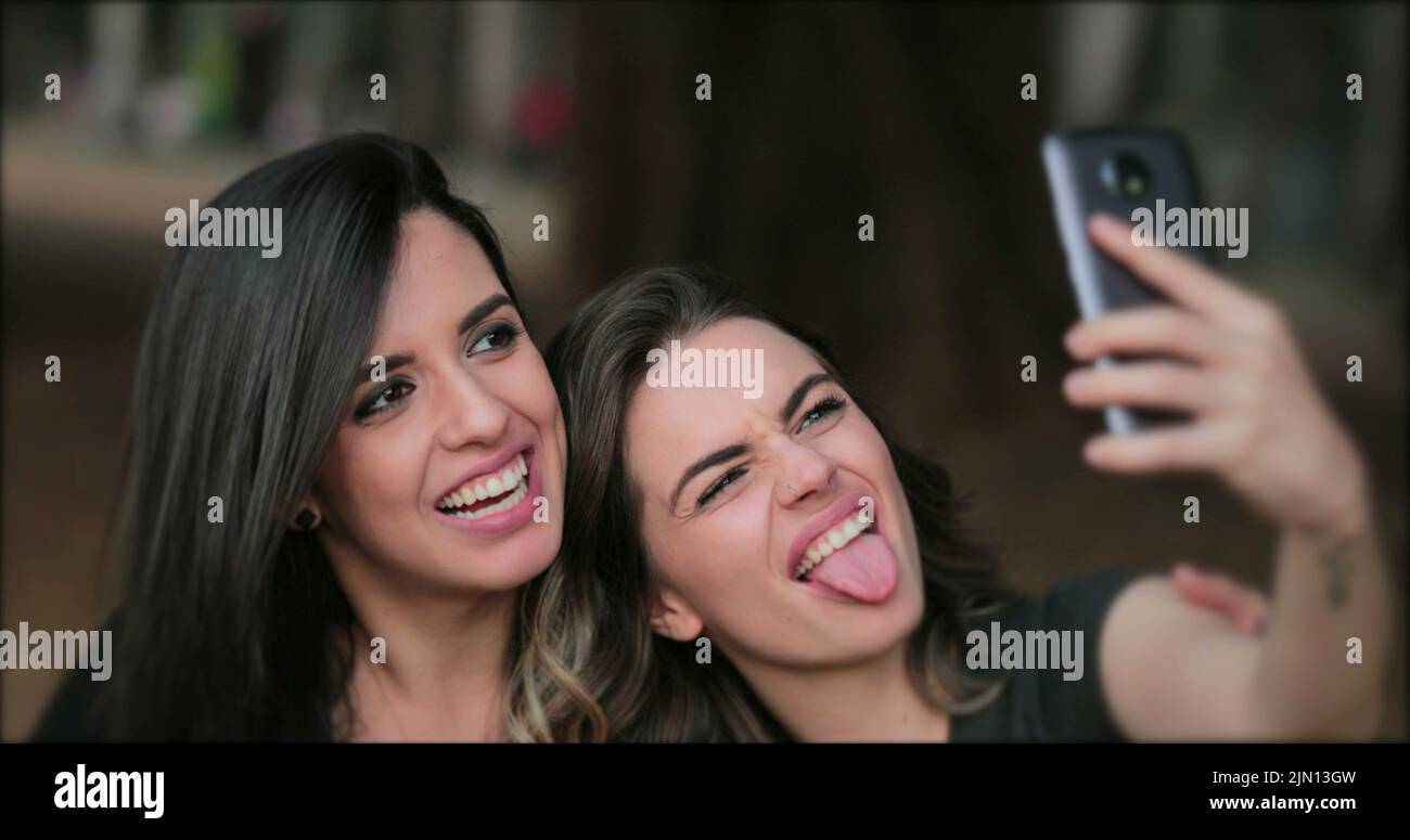 Girlfriends Taking Selfie Sticking Tongue Out Young Women Posing For