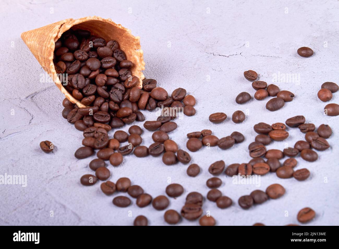 Close up ice cream cone with raw coffee beans. Dessert for drink on ...