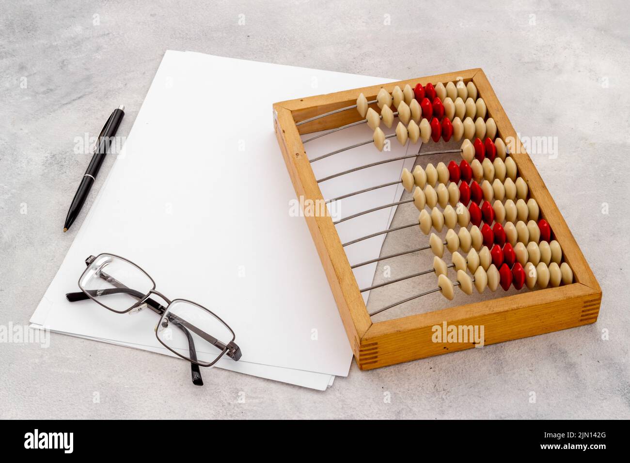 Accounting wooden abacus with blank sheet of paper. Financial ...