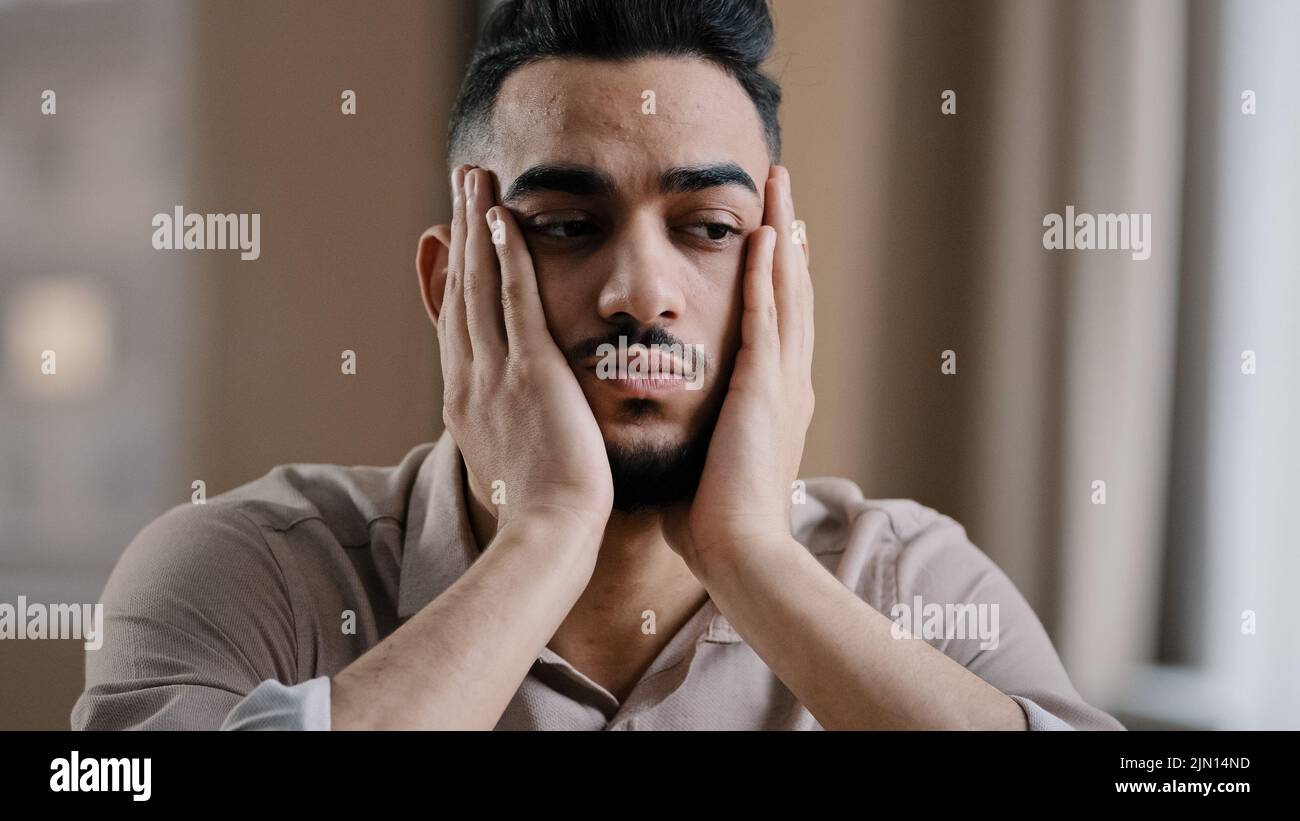 Depressed tired hispanic arab man guy businessman worker sit at home ...