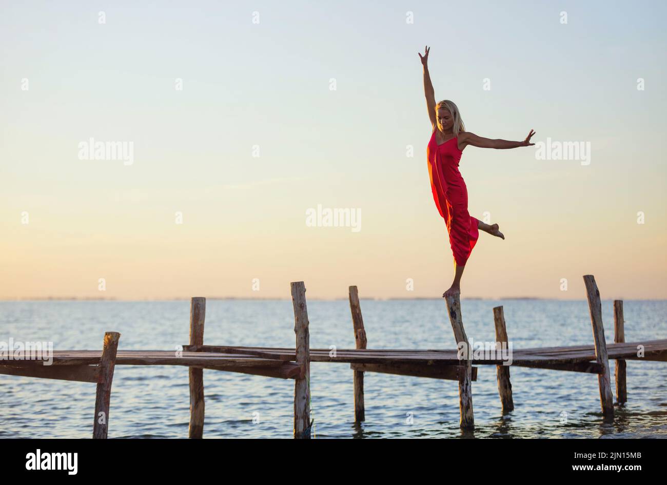 Blonde woman red dress beach hi-res stock photography and images - Alamy
