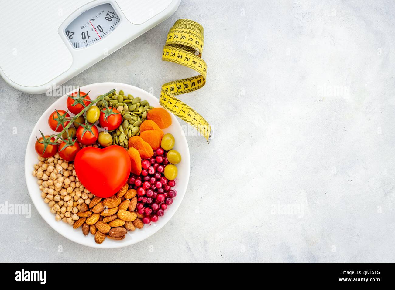 Heart shaped dish of fruits and healthy food with weight scale Stock ...
