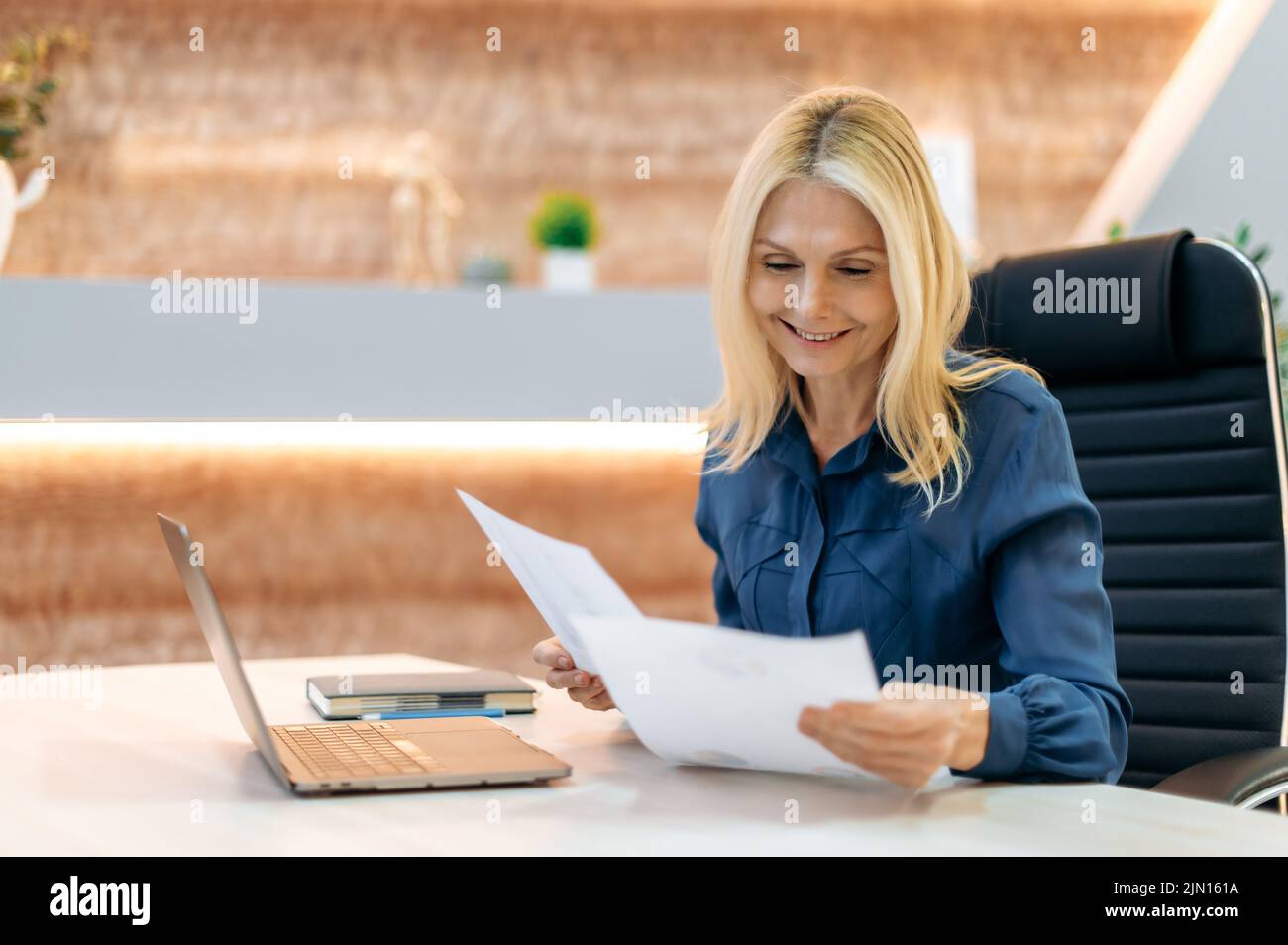 Clever elegant mature caucasian positive female employee, confident ...