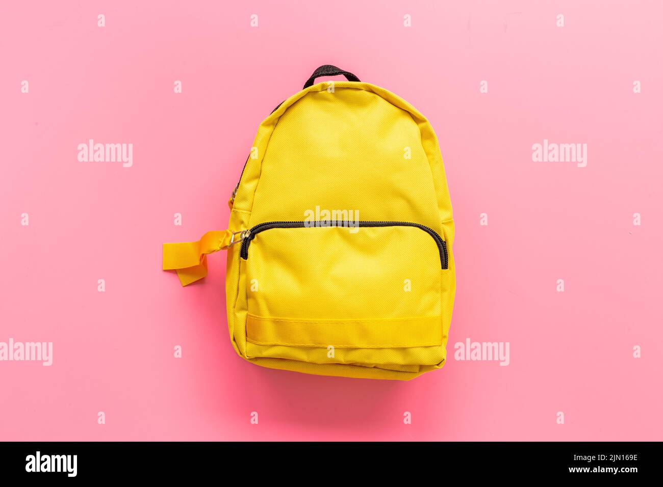 Classic yellow school backpack top view. Educational objects background ...