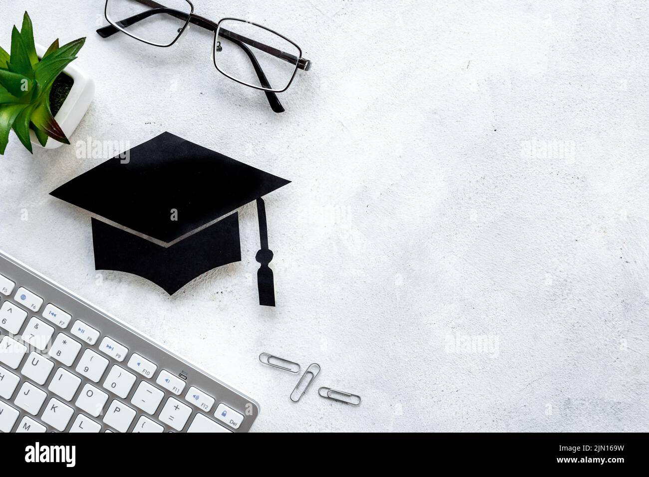 Academic cap or graduation hat on students desk. Education concept ...