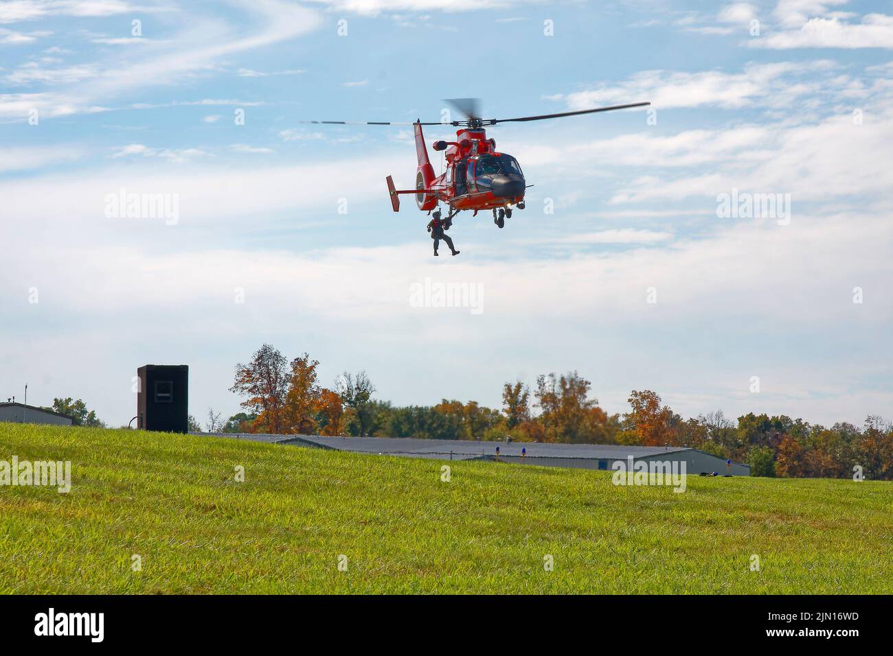 Helicopter flying, U.S. Coast Guard, grass field, rotary-wing aircraft ...