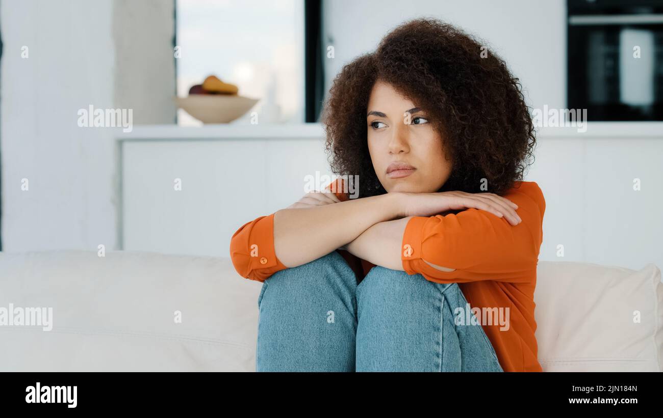 Alone lonely stressed African American woman sitting with sad problem ...