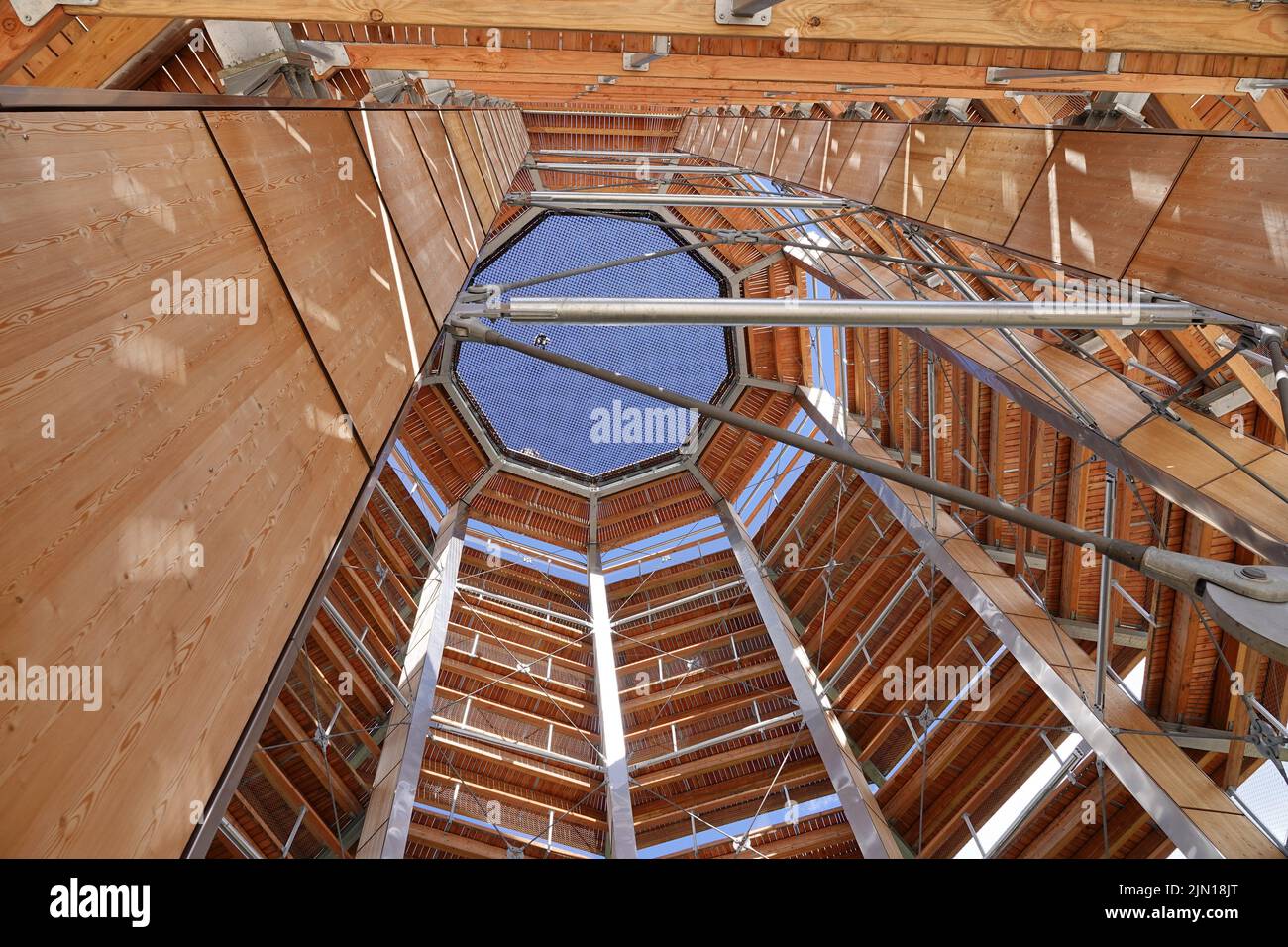 A low angle shot of an interior of a wooden building with a round mesh ...