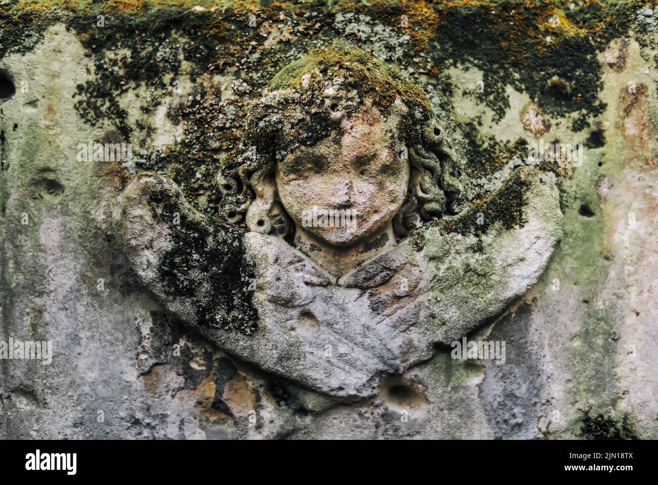 Headstone with Face of Angel Covered in Moss Stock Photo - Alamy