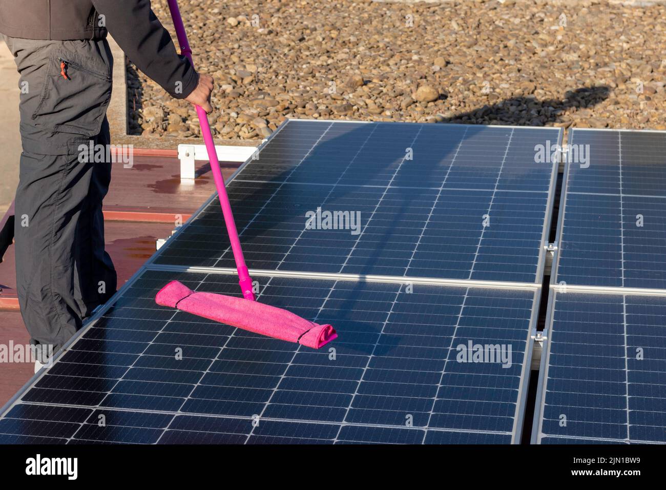 Man cleaning sun panels close hi-res stock photography and images - Alamy