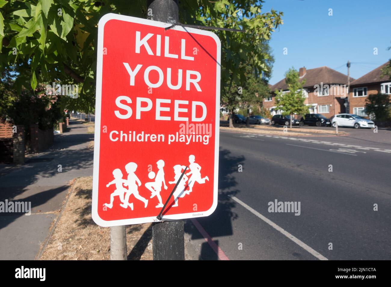 Kill your speed Children playing red notice warning board on a lamp ...