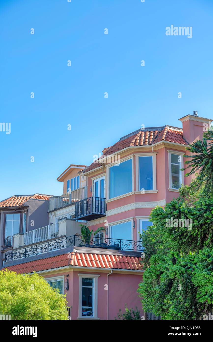 Large houses with painted peach exterior and balconies at San Francisco ...