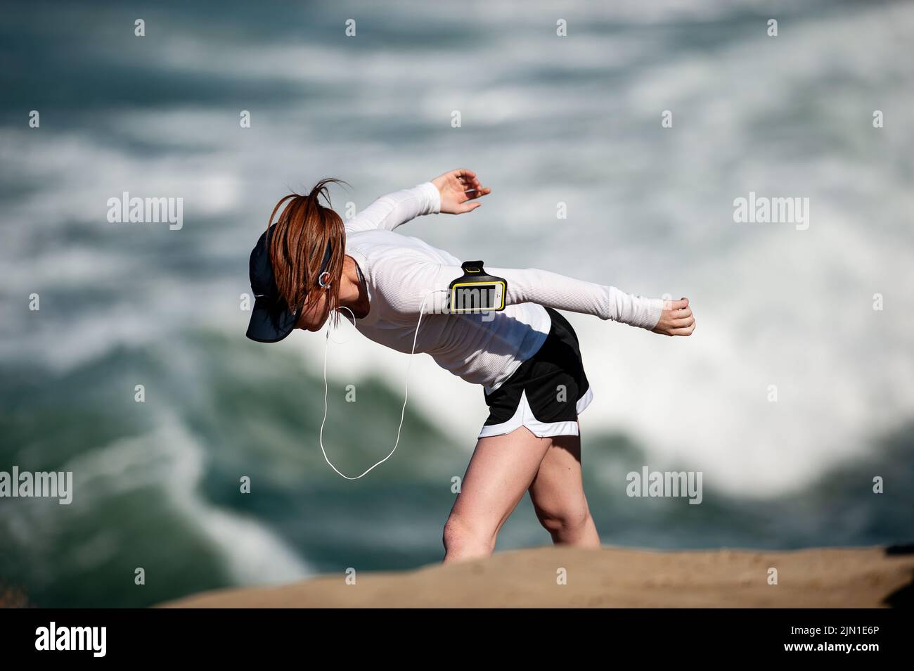 Stock Image Of A Woman Stretching Before Her Morning Beach Run Runner Warming Up Beach Runner