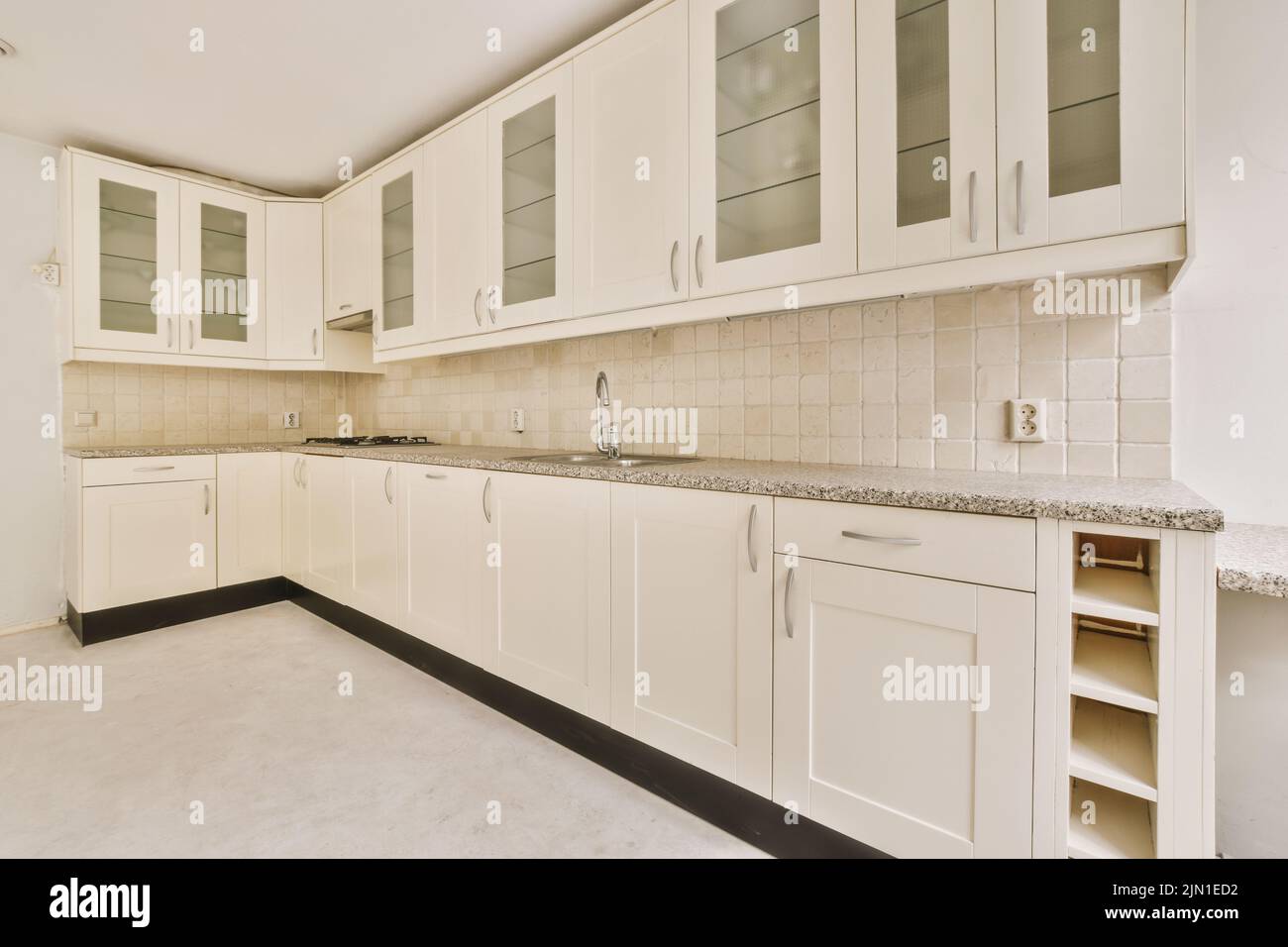 Interior of empty white kitchen with windows and wooden parquet floor ...