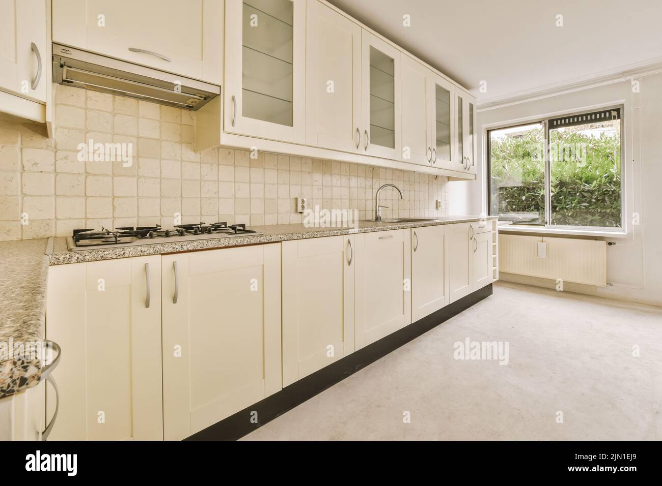Interior of empty white kitchen with windows and wooden parquet floor ...