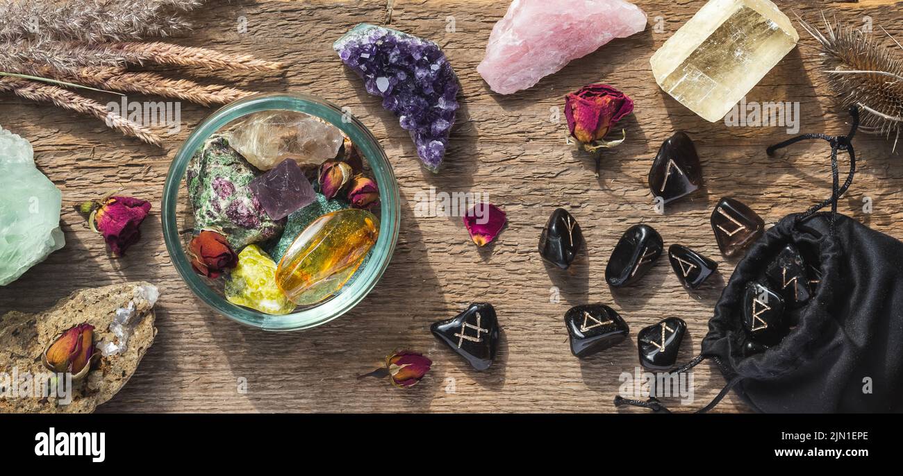 Natural minerals and rune stones set up on wood. Magical ritual process ...