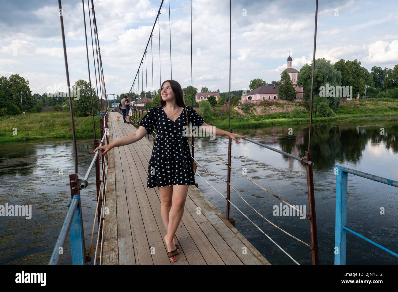 Moscow region. The girl on the suspension bridge through the Moskva ...