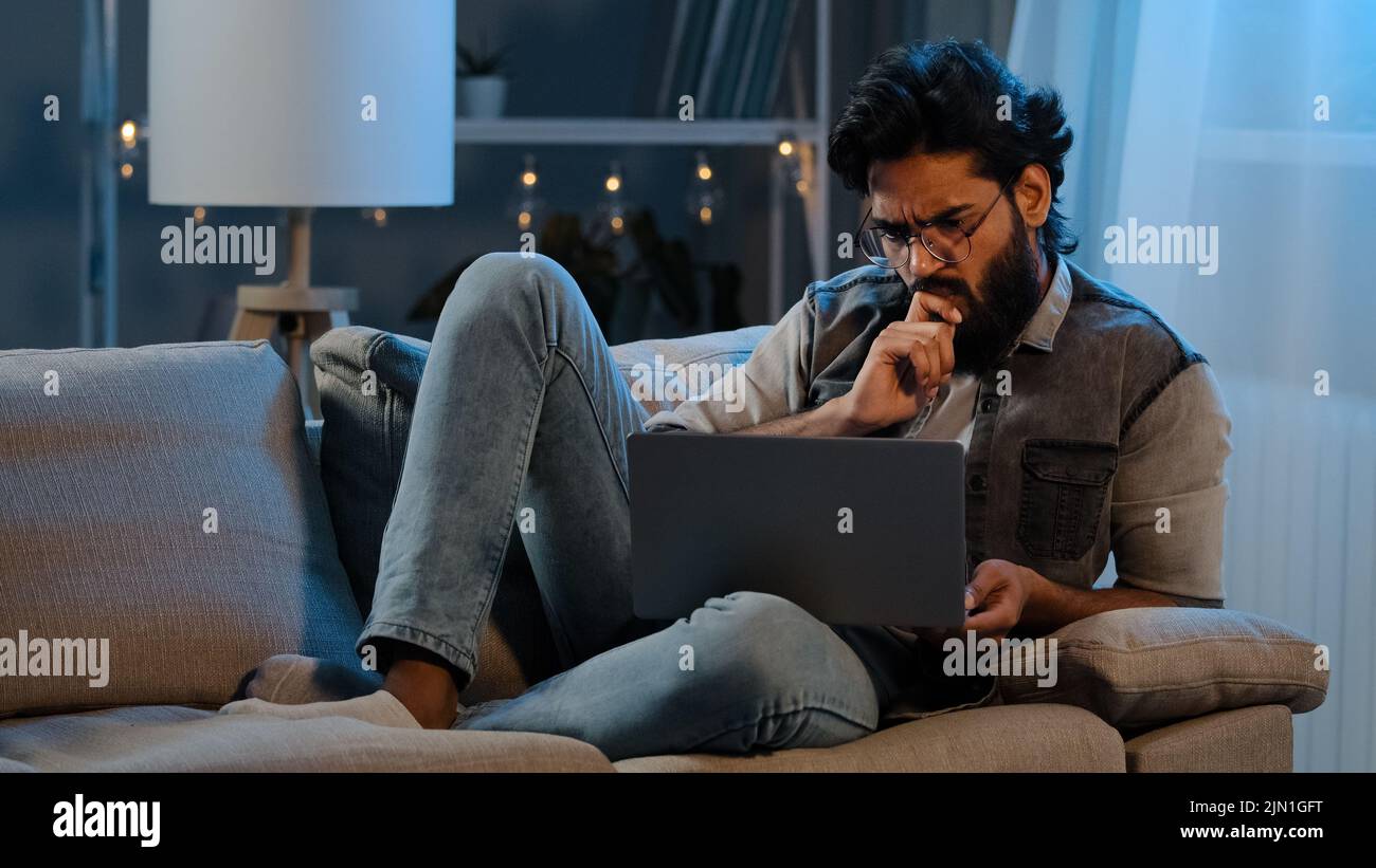 Businessman guy Arab Indian man bearded user wearing glasses sitting on ...