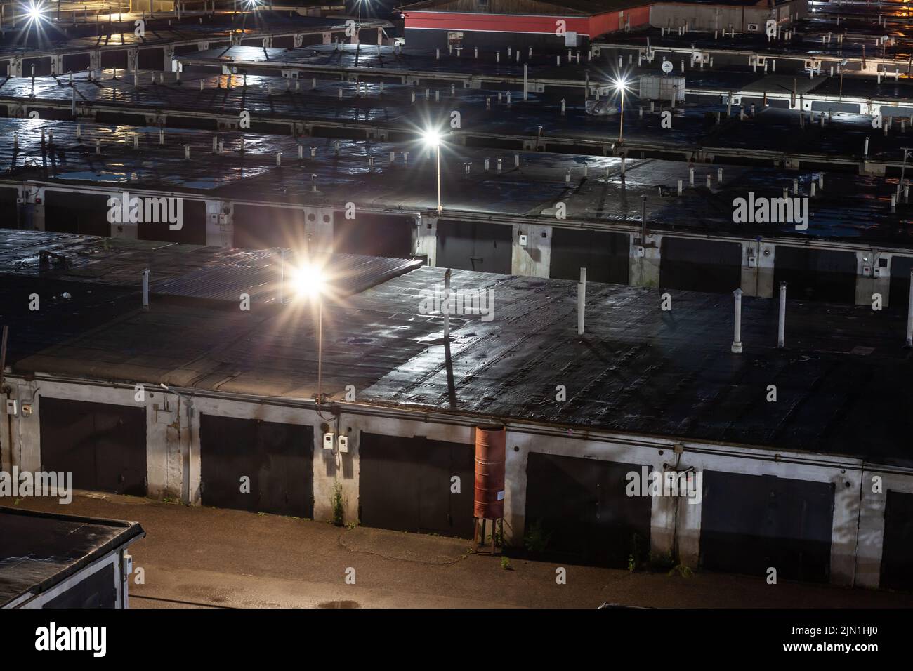 Beautiful night landscape garages stand in rows and a lantern that ...