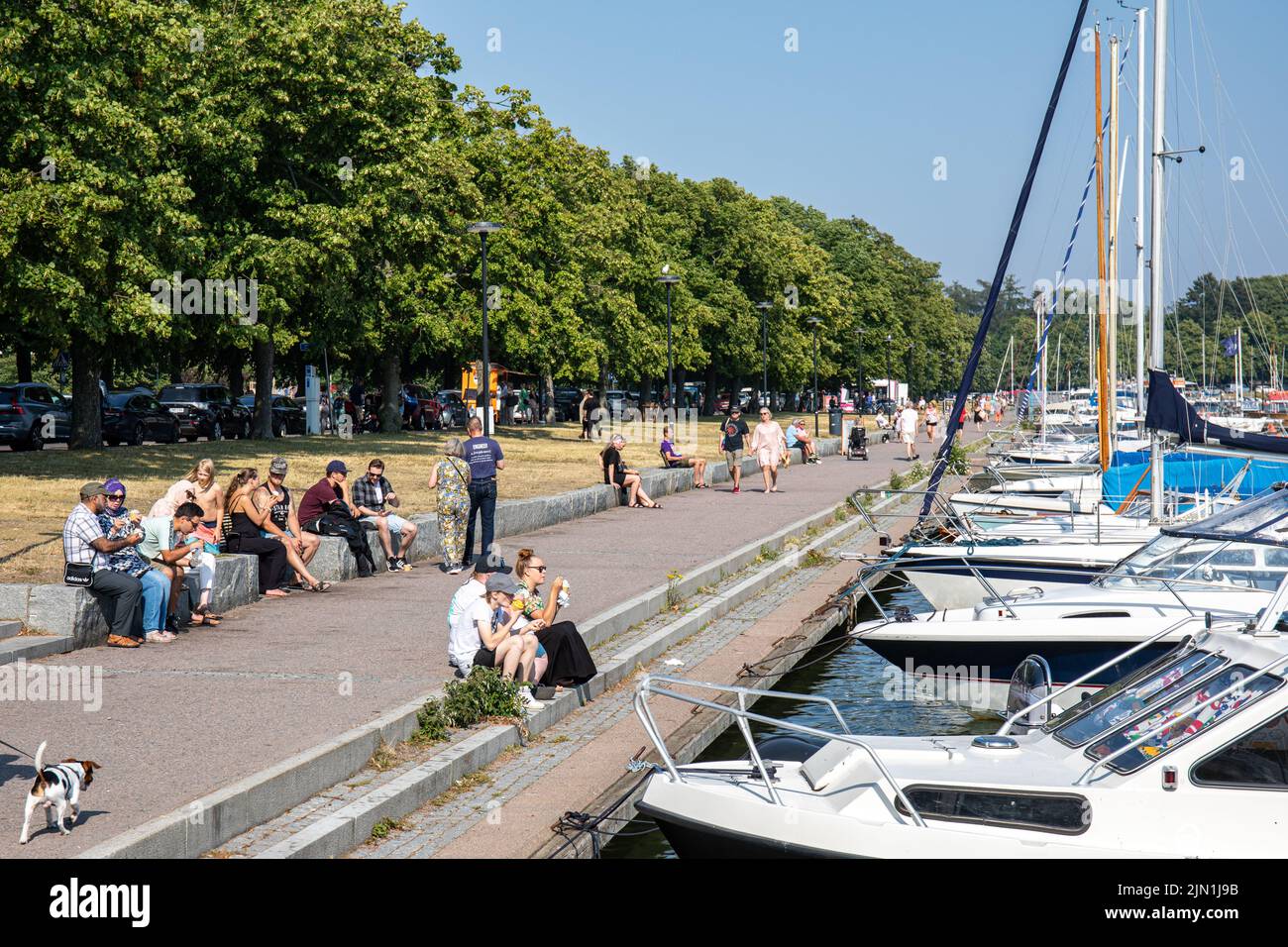 People eating ice cream at waterfront in Merisatama in Ullanlinna ...