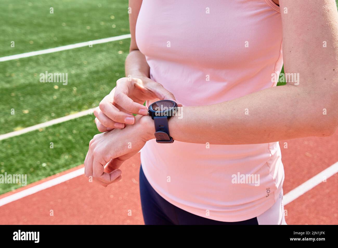Woman use fitness watch before cardio exercises, Checking results on ... Woman use fitness watch before cardio exercises, Checking results on ...