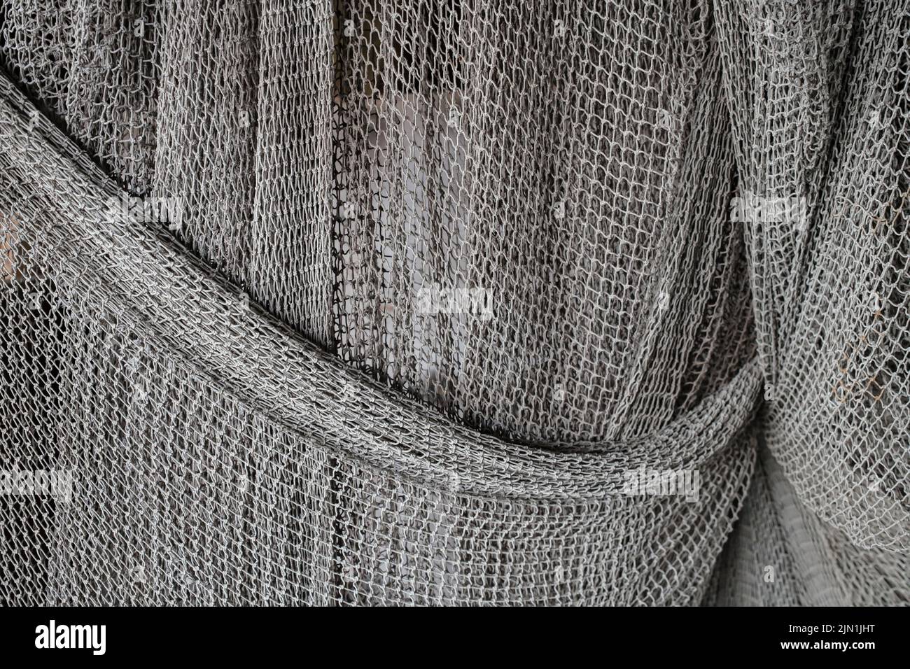 Old fishing nets hung along the walls background Stock Photo - Alamy