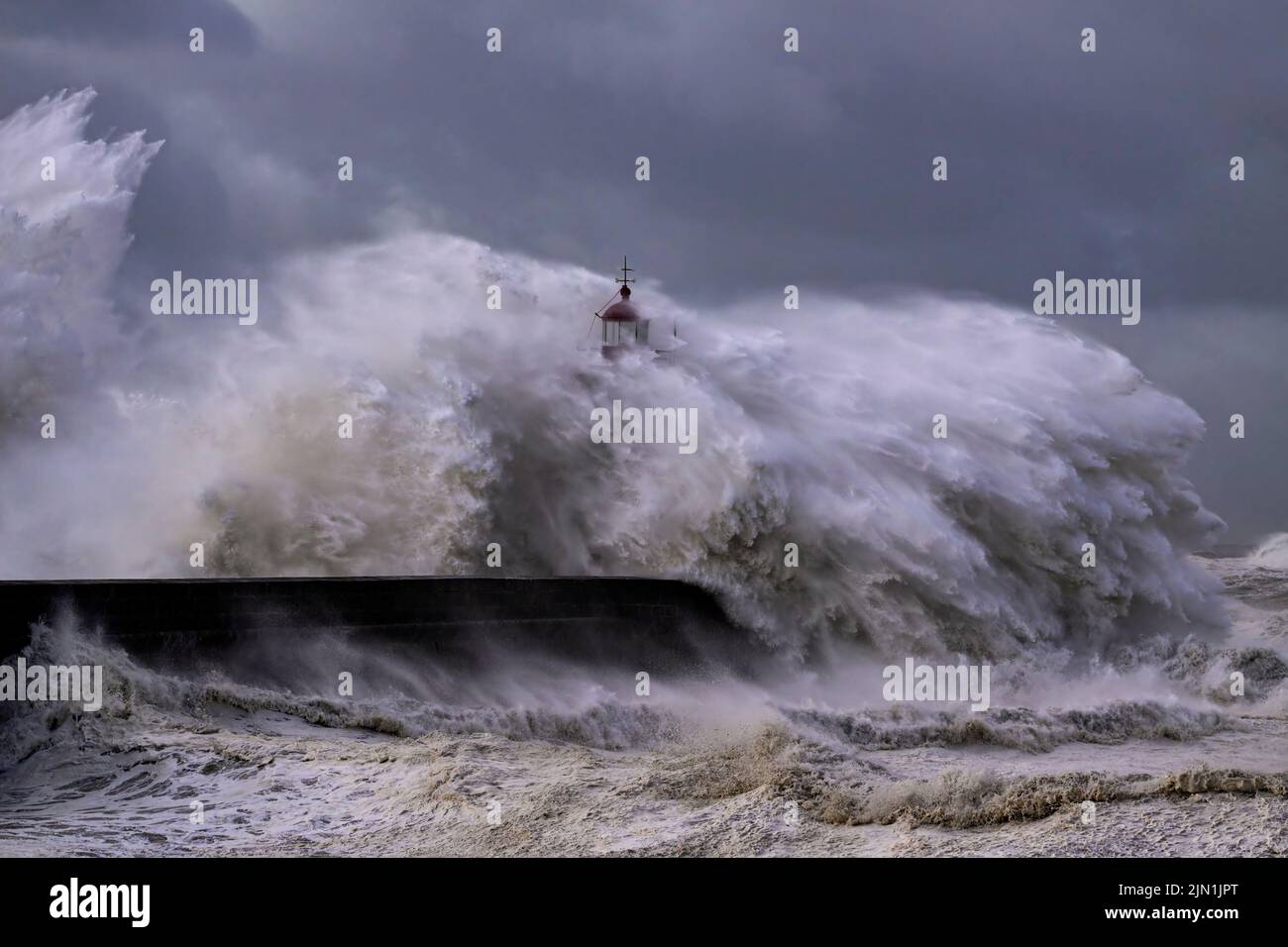 Huge stormy wave splash. Douro river mouth old lighthouse and granite ...