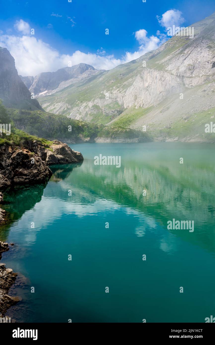 mist rolls across the barrage des gloriettes, a large reservoir and dam ...
