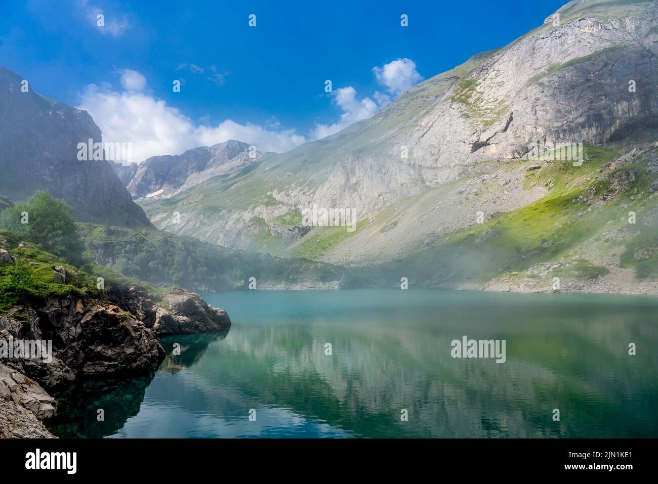 mist rolls across the barrage des gloriettes, a large reservoir and dam ...