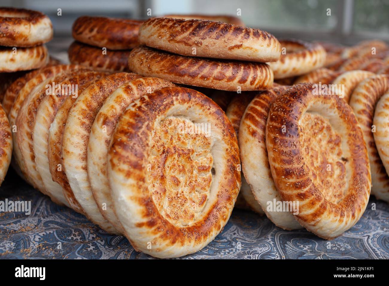Typical traditional flatbread with crunchy crust with sesam just baked ...