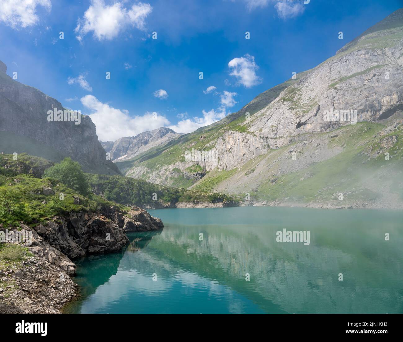 mist rolls across the barrage des gloriettes, a large reservoir and dam ...